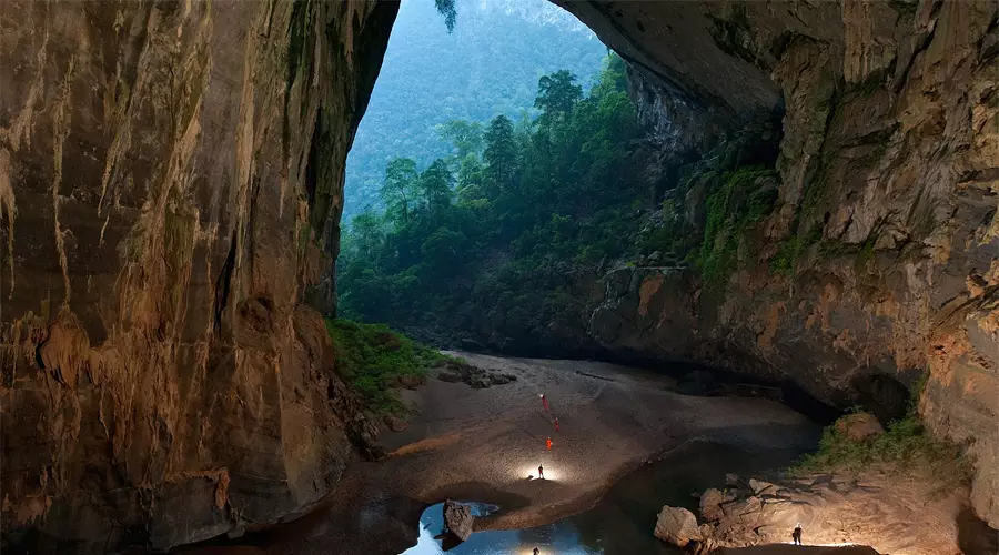 Son Dong Cave Vietnam Lub qhov tsua yog nyob rau Nyab Laj Nyab Laj, hauv xeev Quang Binh. Shondong nyob hauv Fongya Kebang National Park, 500 kilometers sab qab teb ntawm Hanoi. Ntawm no, cov kws tshawb nrhiav pom cov tsev mus txog 200 metres hauv qhov siab thiab 150 metres hauv qhov dav, uas ua rau nws muaj peev xwm cais Shondong ua qhov tsua loj tshaj plaws hauv ntiaj teb. Hauv qee qhov chaw qab nthab ntawm lub qhov tsua tau tawg. Los ntawm cov qhov no, lub teeb nkag mus rau hauv lub qhov tsua, ua tsaug rau lub hav zoov tiag tiag tau loj hlob hauv nws, uas liab, noog thiab kab nyob.