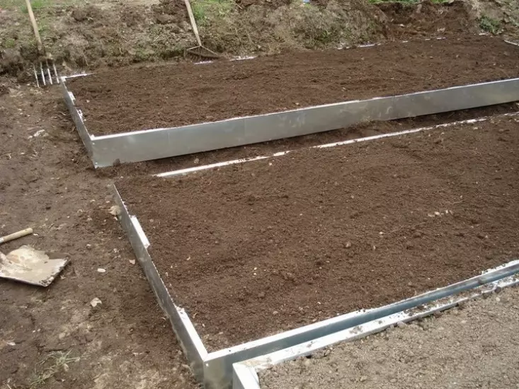 Geplant Grenzen Bepaal de grenzen van toekomstige gewassen door paden tussen de bedden te betreden of ze te versterken met alle beschikbare bouwmaterialen. De tweede methode is betrouwbaarder - u zult duidelijk zien waar u hem plaatst.