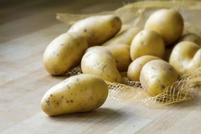 new potatoes on a wooden kitchen board