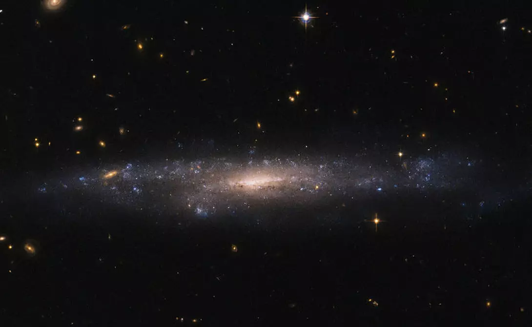 Dance of a black hole Most likely (astronomers themselves are not sure here), the telescope managed to capture the rarest moment of merging of black holes. The visible jets are particles stretching for an incredible distance of several thousand light years.