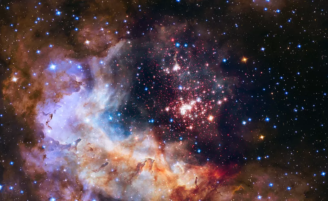 Celestial Fireworks Inside the image, many young stars can be seen congregated in a hazy haze of cosmic dust. Columns of dense gas become incubators where new cosmic life is born.