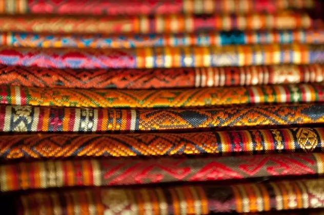 Industrie textile du Laos Luang Prabang est considérée comme le centre de l'industrie textile au Laos. Les tisserands traditionnels, comme les membres de la tribu Katu, fabriquent toujours les mêmes motifs en utilisant les mêmes techniques que leurs ancêtres utilisaient il y a des centaines d'années. Ces dernières années, ce pays asiatique appauvri a connu un essor de l'industrie du tourisme. En 2012, le Laos a reçu plus de 3,3 millions de touristes étrangers, principalement de Chine et de Thaïlande. Alors que l'augmentation significative du nombre de visiteurs étrangers profite à l'industrie du tourisme, elle a eu un impact négatif sur l'industrie textile. L'afflux accru de touristes a entraîné une augmentation de la demande de produits textiles laotiens. Afin de répondre à l'augmentation soudaine de la demande, les commerçants ont eu recours à la vente de textiles lao contrefaits.